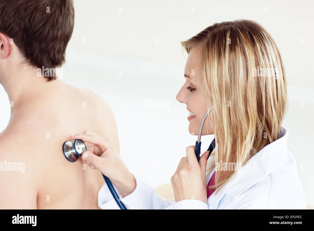 attractive female doctor using stethoscope on her patient's back Stock ...