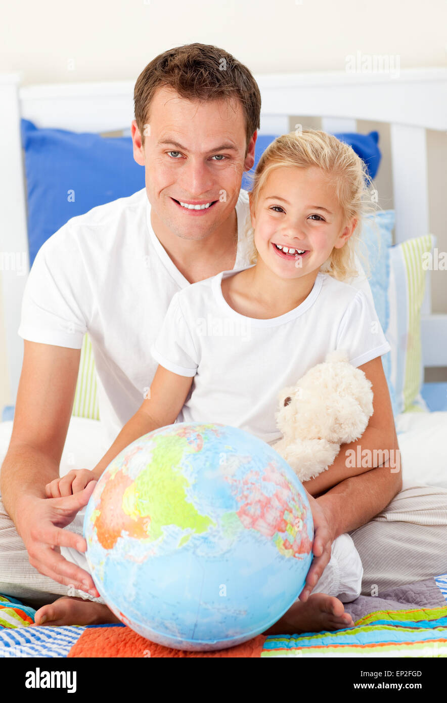 Attentive father and his daugther looking at a terrestrial globe Stock ...