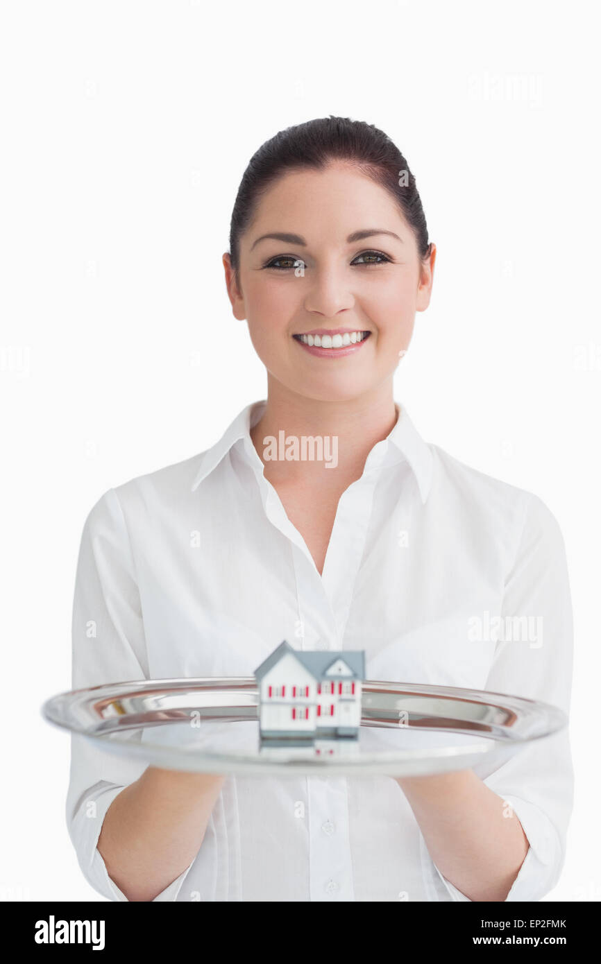Smiling waitress holding tray with miniature house Stock Photo - Alamy