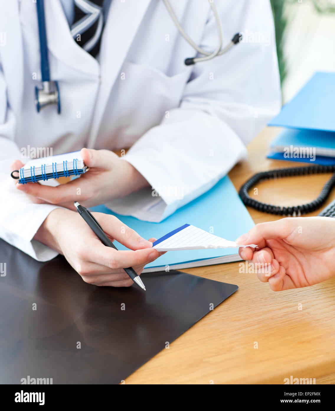 A doctor giving his patient a prescription Stock Photo - Alamy