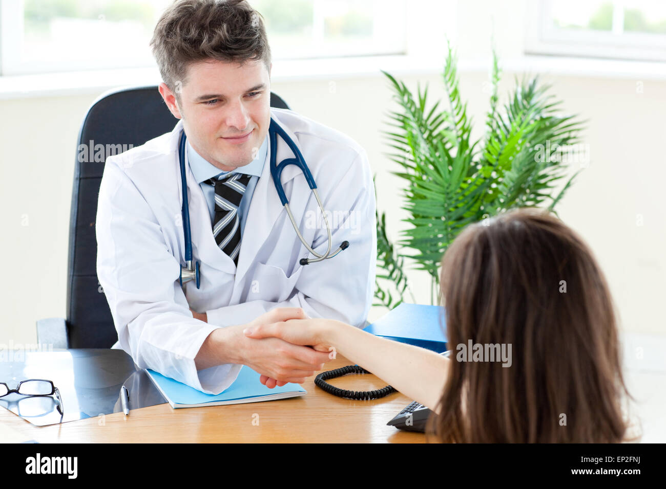 Delighted male doctor welcome his patient Stock Photo - Alamy