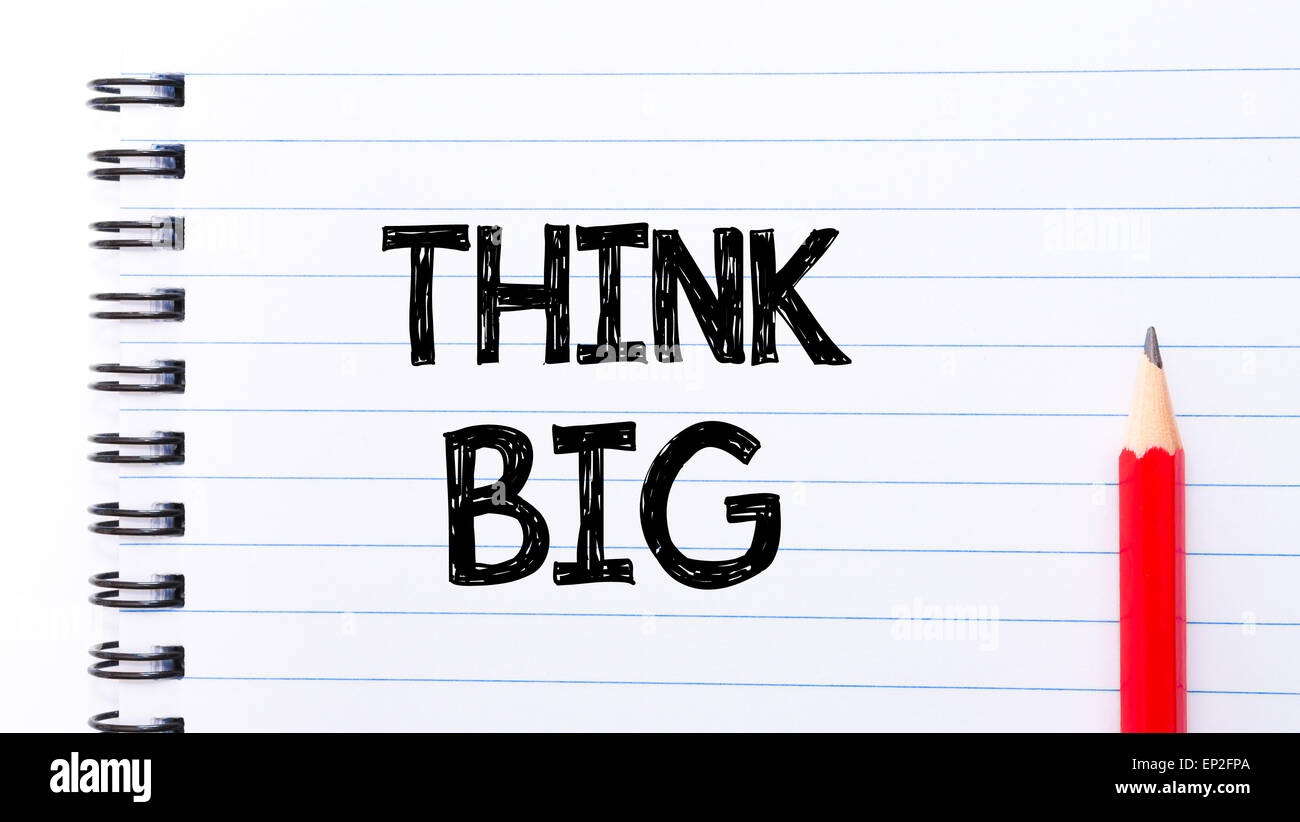 Think Big Text written on notebook page, red pencil on the right ...