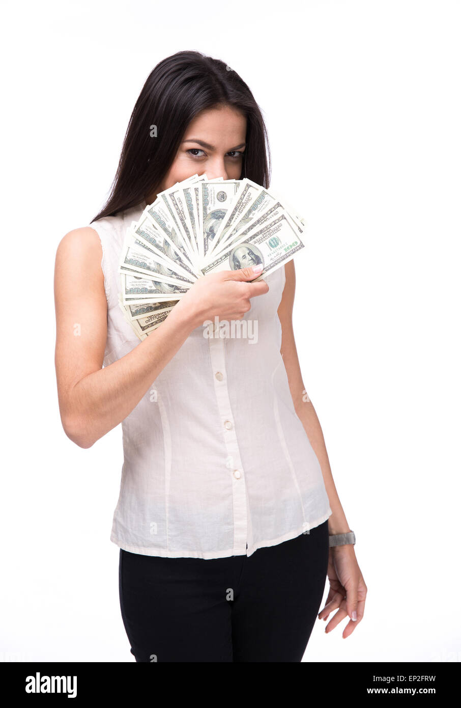 Young woman covering face with money isolated on a white background ...
