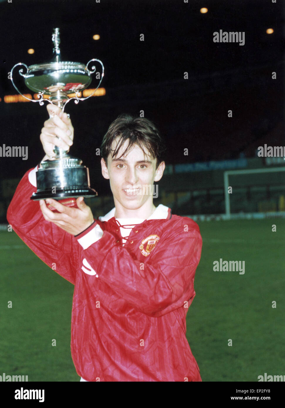 Manchester United youth team player Gary Neville holds up the FA ...