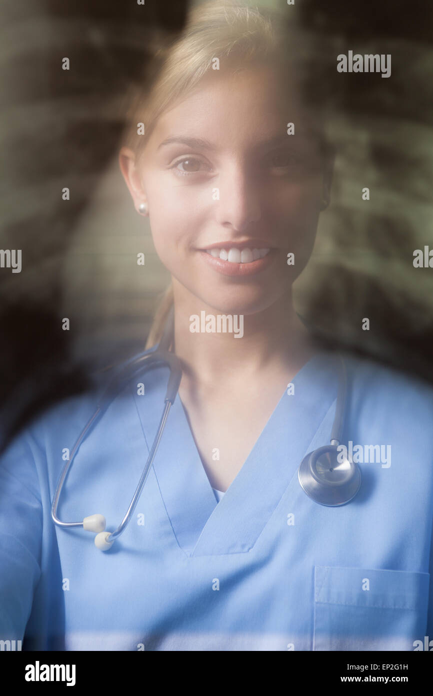 Young female doctor with blurred x-ray background Stock Photo - Alamy