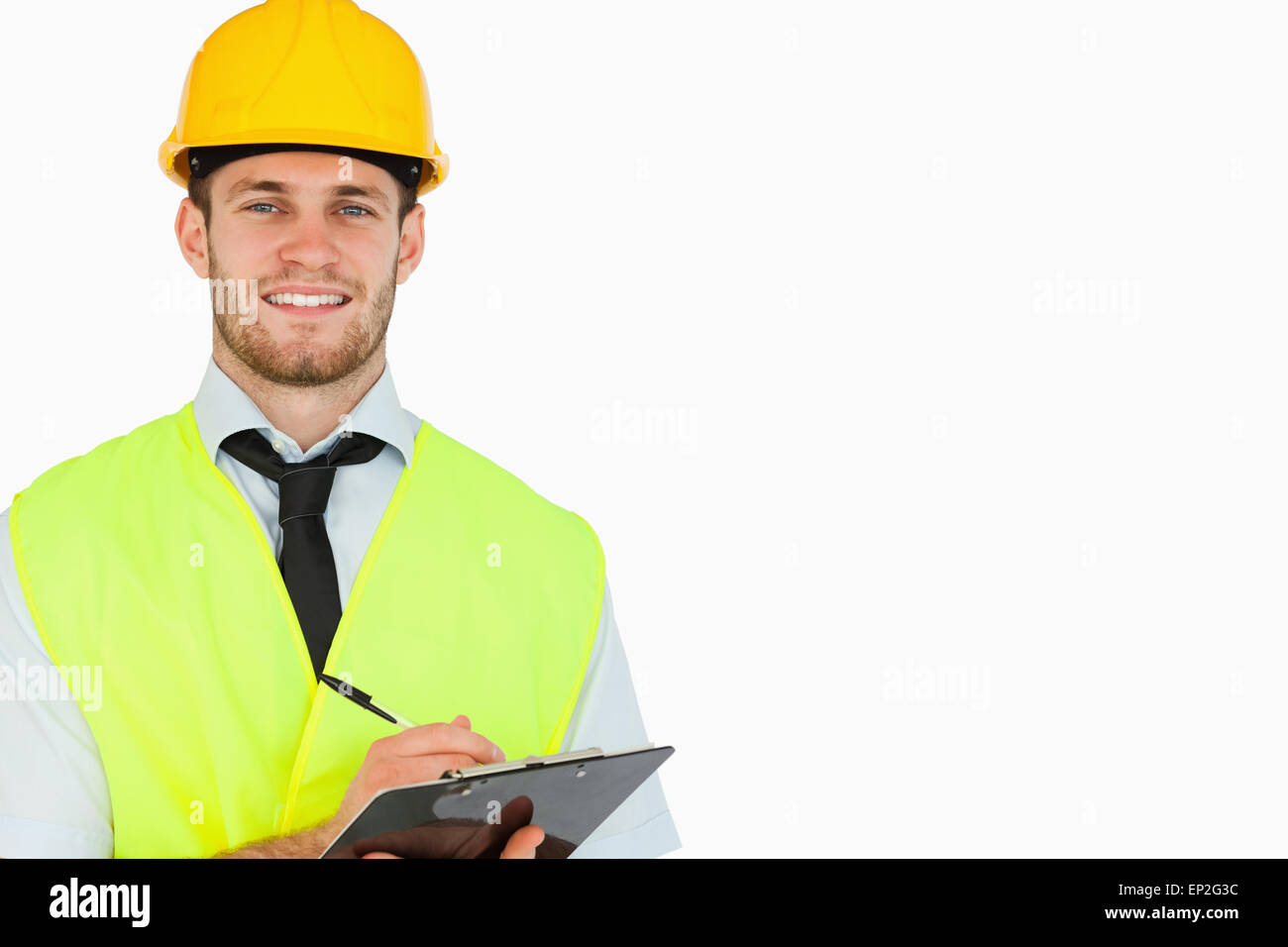 Smiling young lead worker with clipboard Stock Photo - Alamy