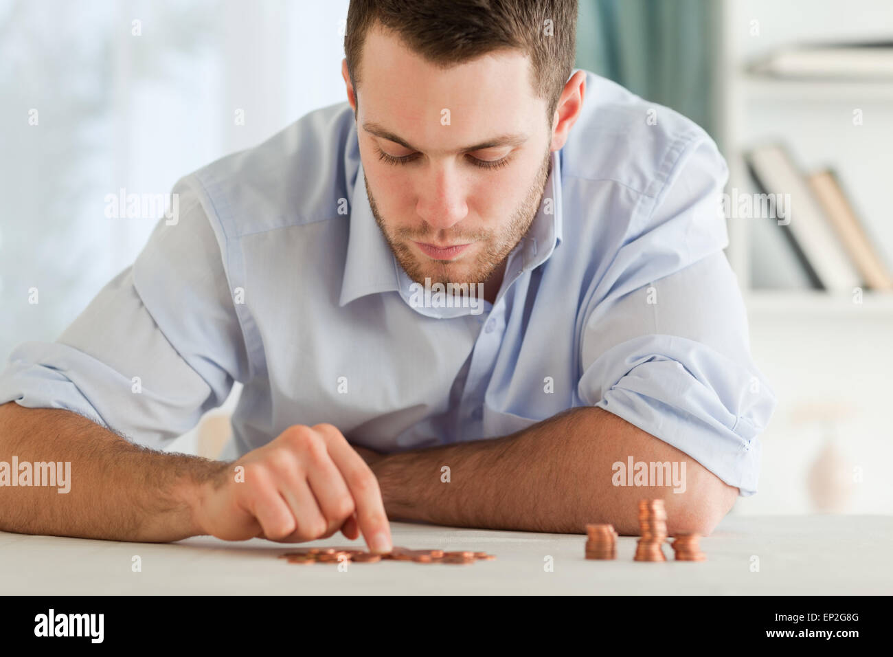 Businessman counting his small change Stock Photo - Alamy