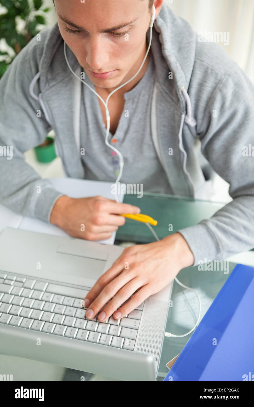 High-angle view of a student doing his homework while helping with a ...