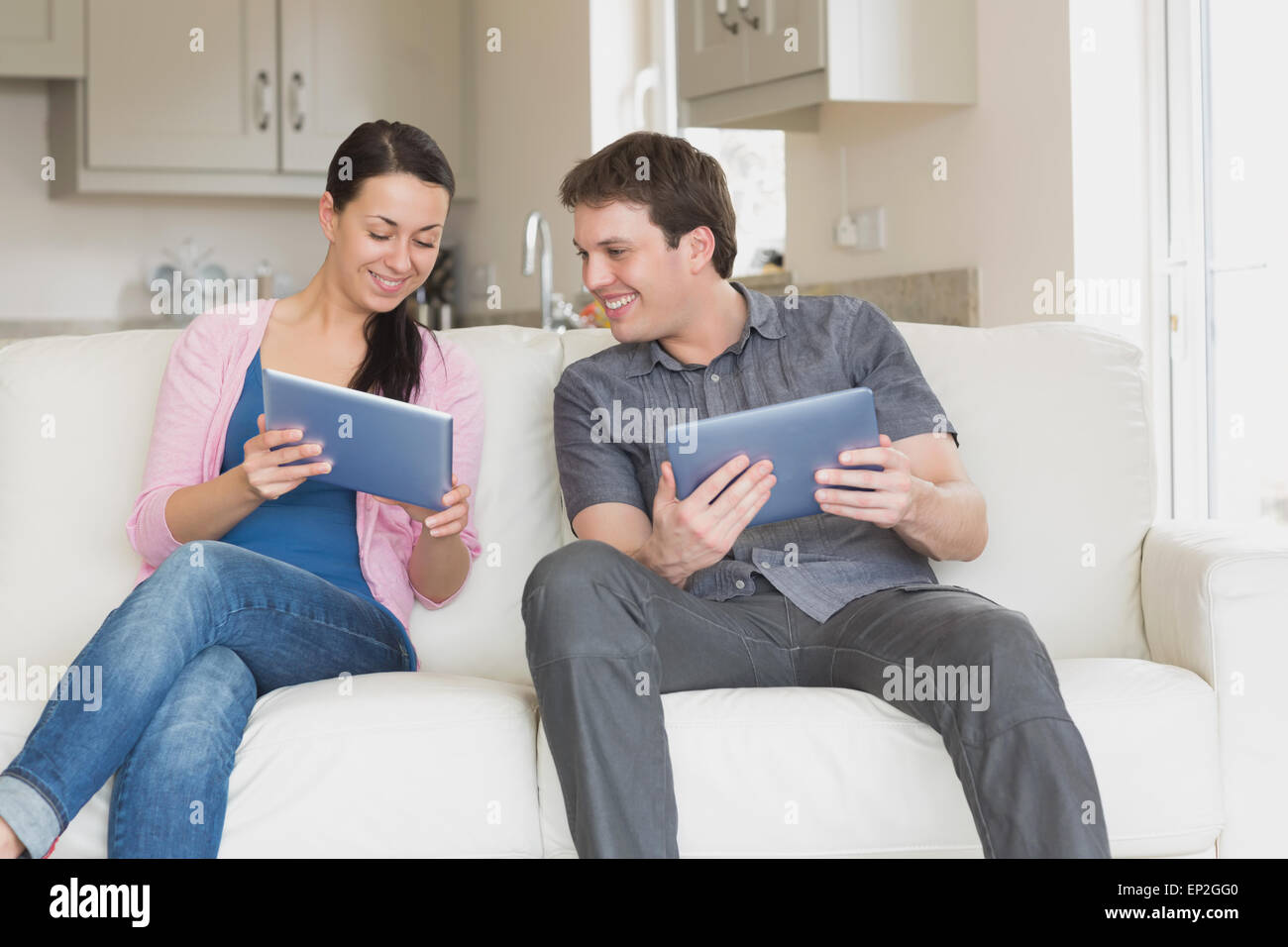 Two friends working with their tablet computers Stock Photo - Alamy