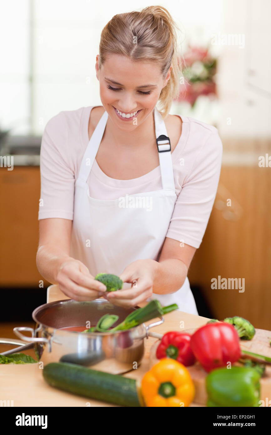 Portrait of a young woman cooking Stock Photo - Alamy
