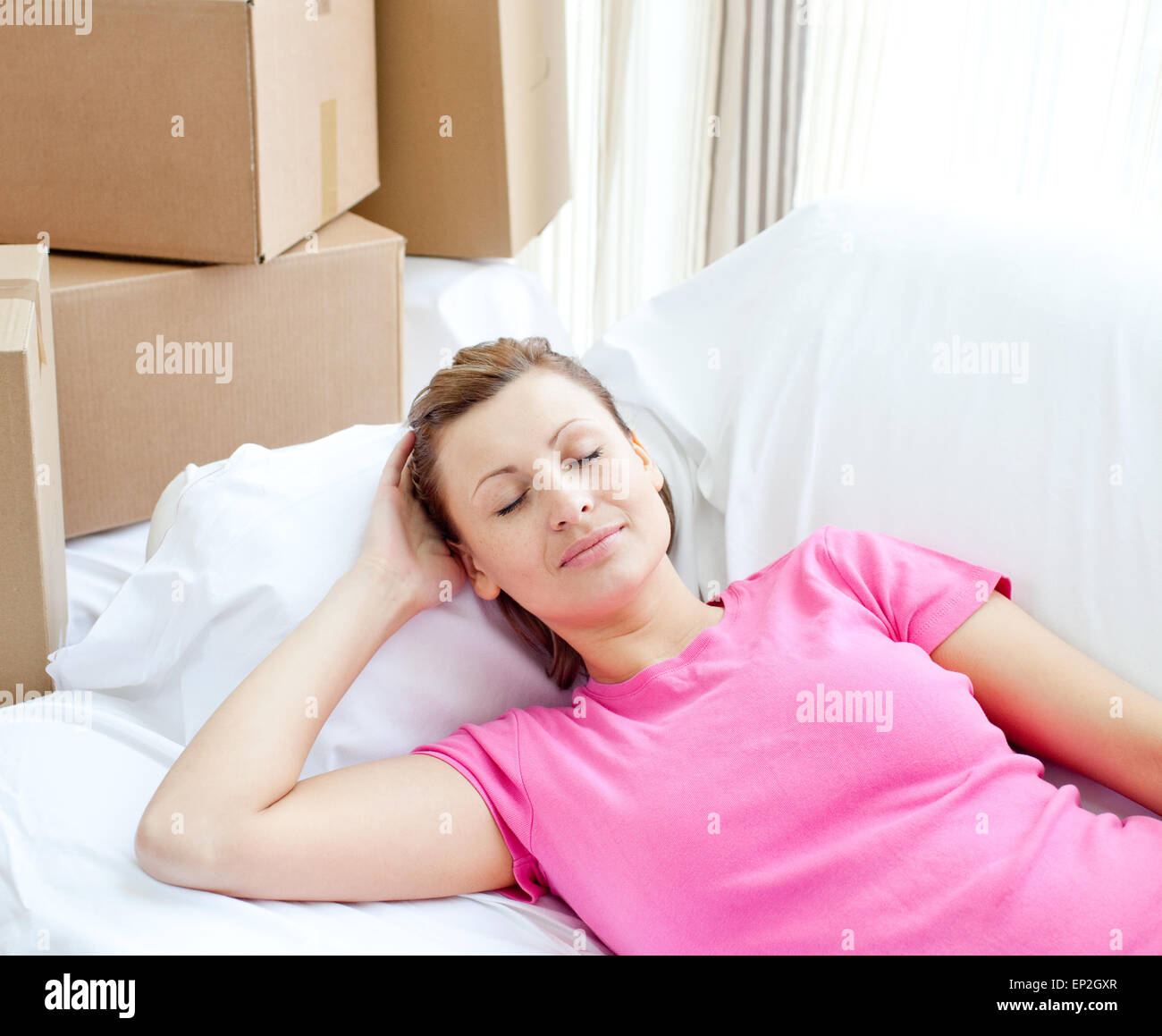 Sleeping woman relaxing on a sofa with boxes Stock Photo - Alamy