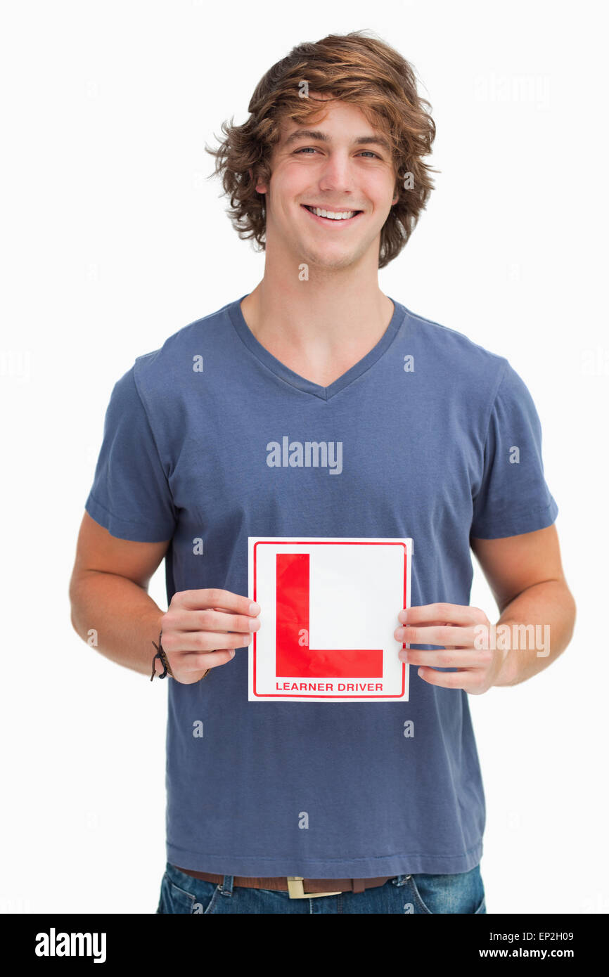 Smiling young man holding a learner driver sign Stock Photo - Alamy