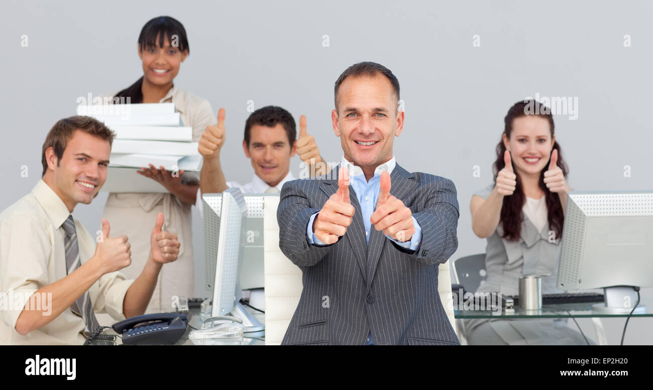 Assertive manager and his team with thumbs up Stock Photo - Alamy