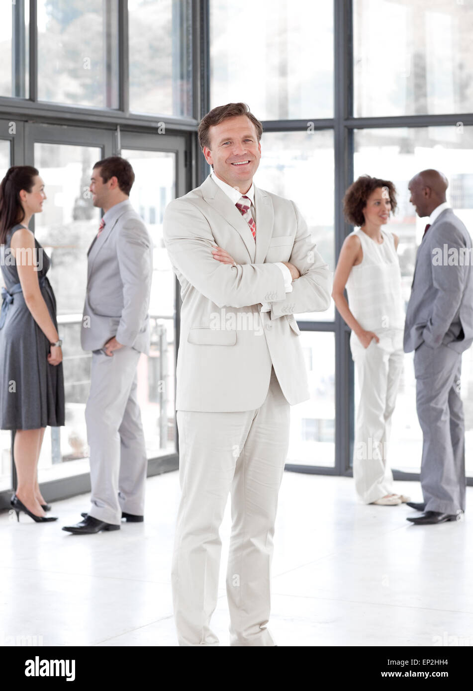 portrait of a smiling male manager leading his team Stock Photo - Alamy