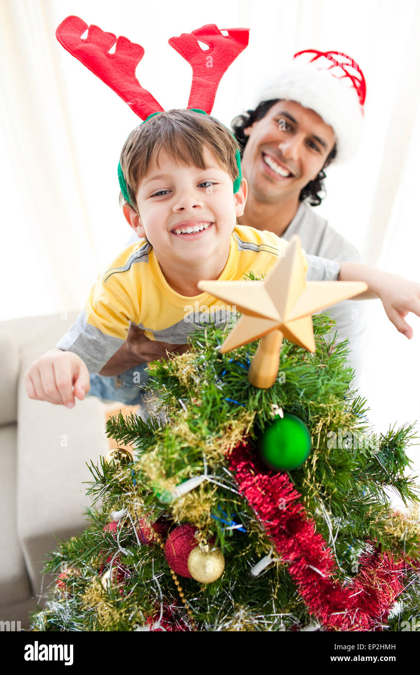 Father and son decorating a Christmas tree Stock Photo - Alamy