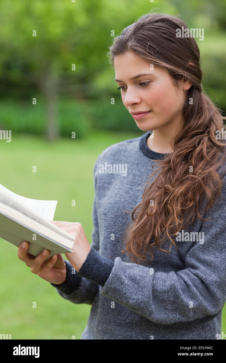 Young relaxed adult reading a book in the countryside Stock Photo - Alamy