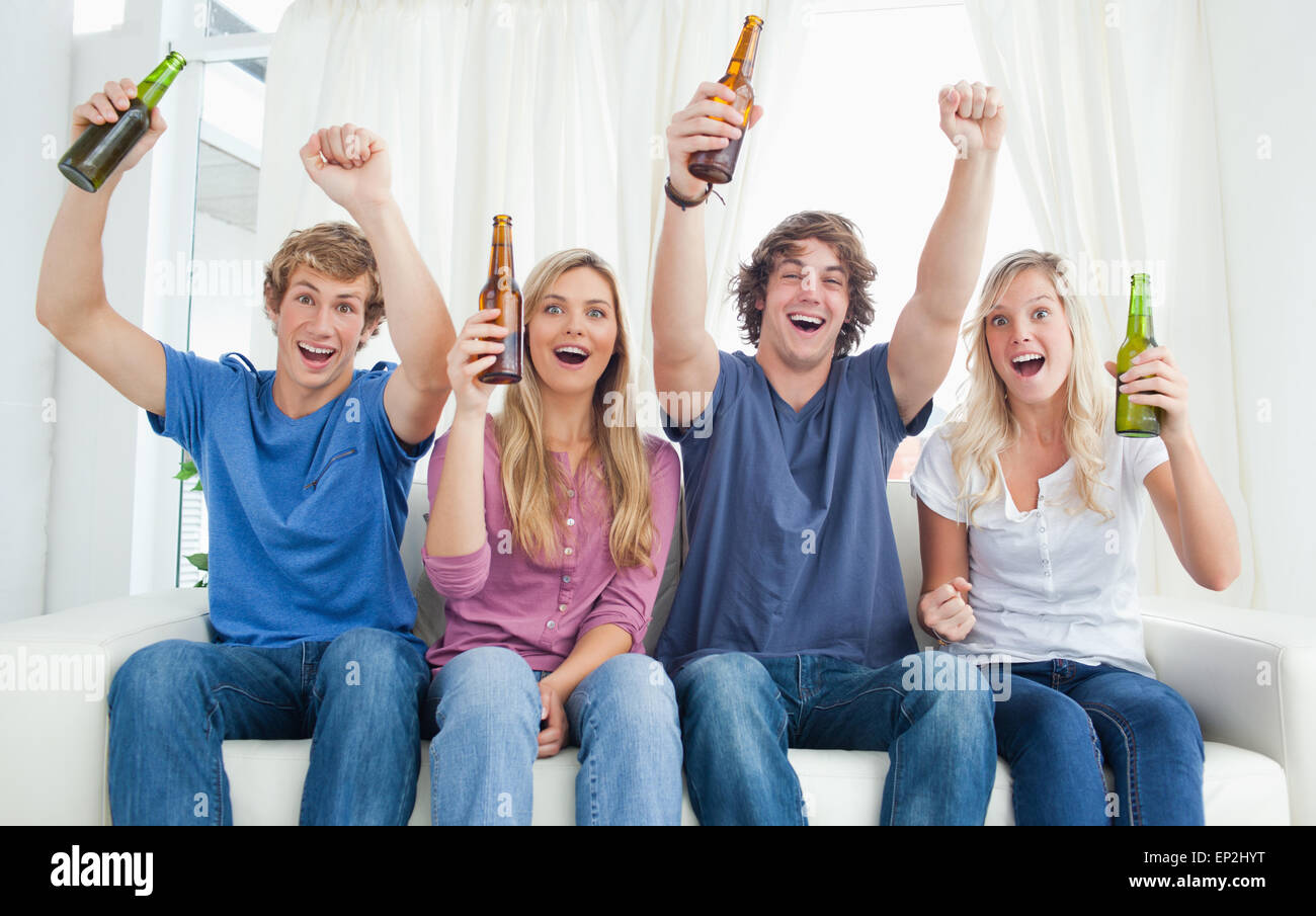 Cheering group of friends looking at the camera Stock Photo - Alamy