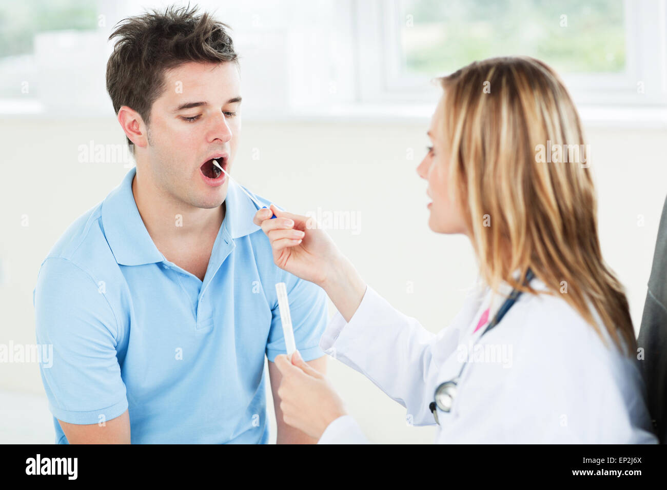 Female doctor extracting saliva Stock Photo - Alamy
