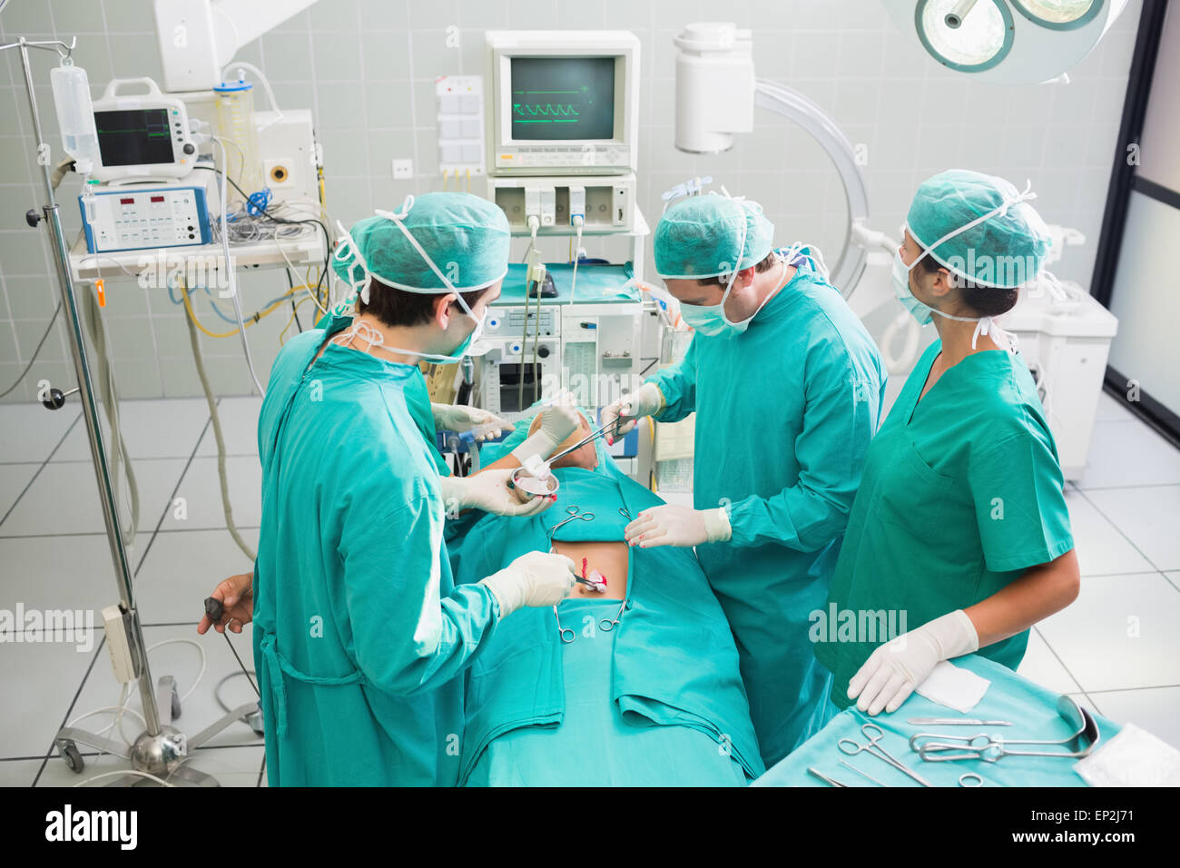 Surgeons operating a patient in an operating theater Stock Photo - Alamy