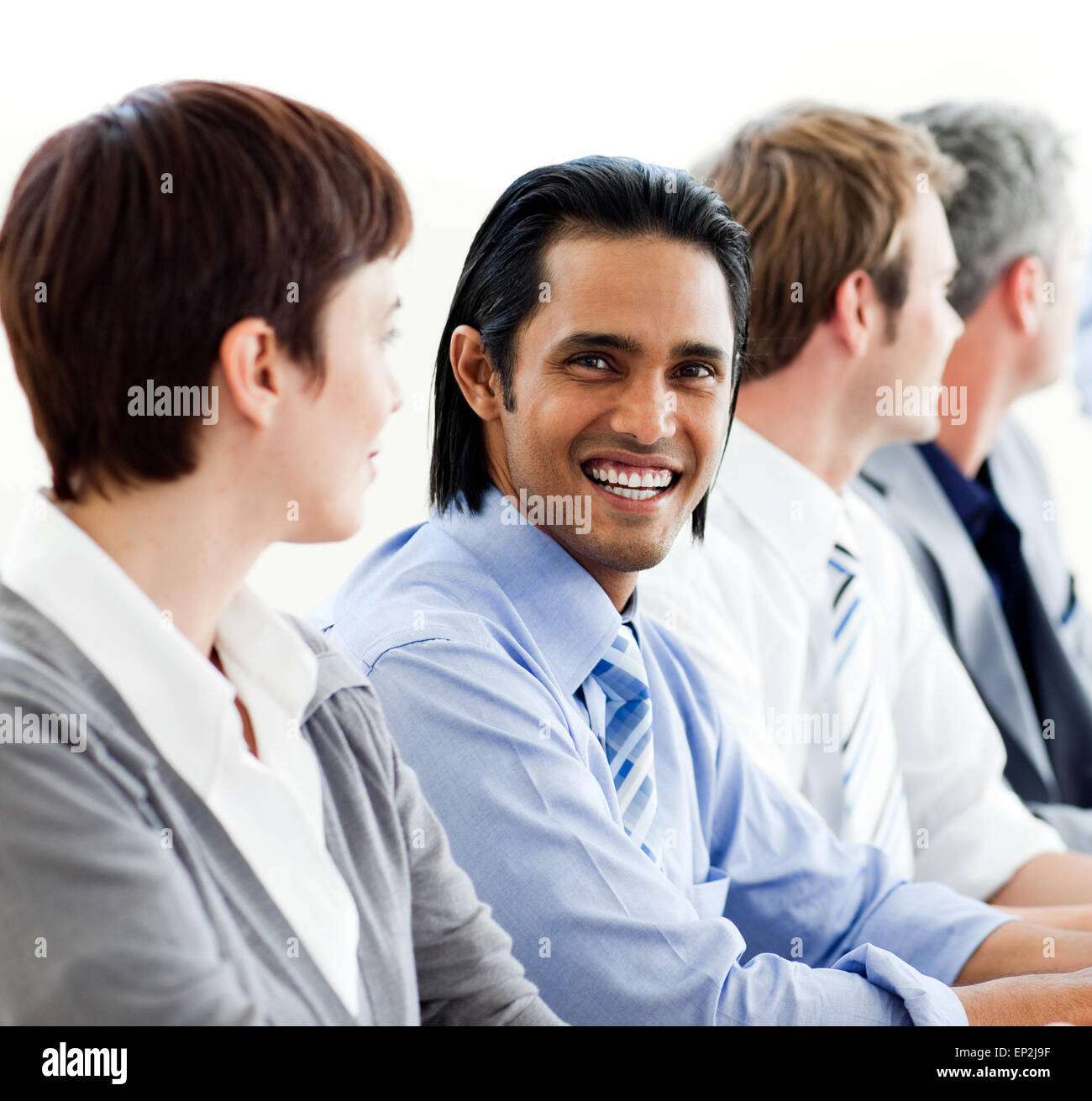 International business people sitting in a row Stock Photo - Alamy