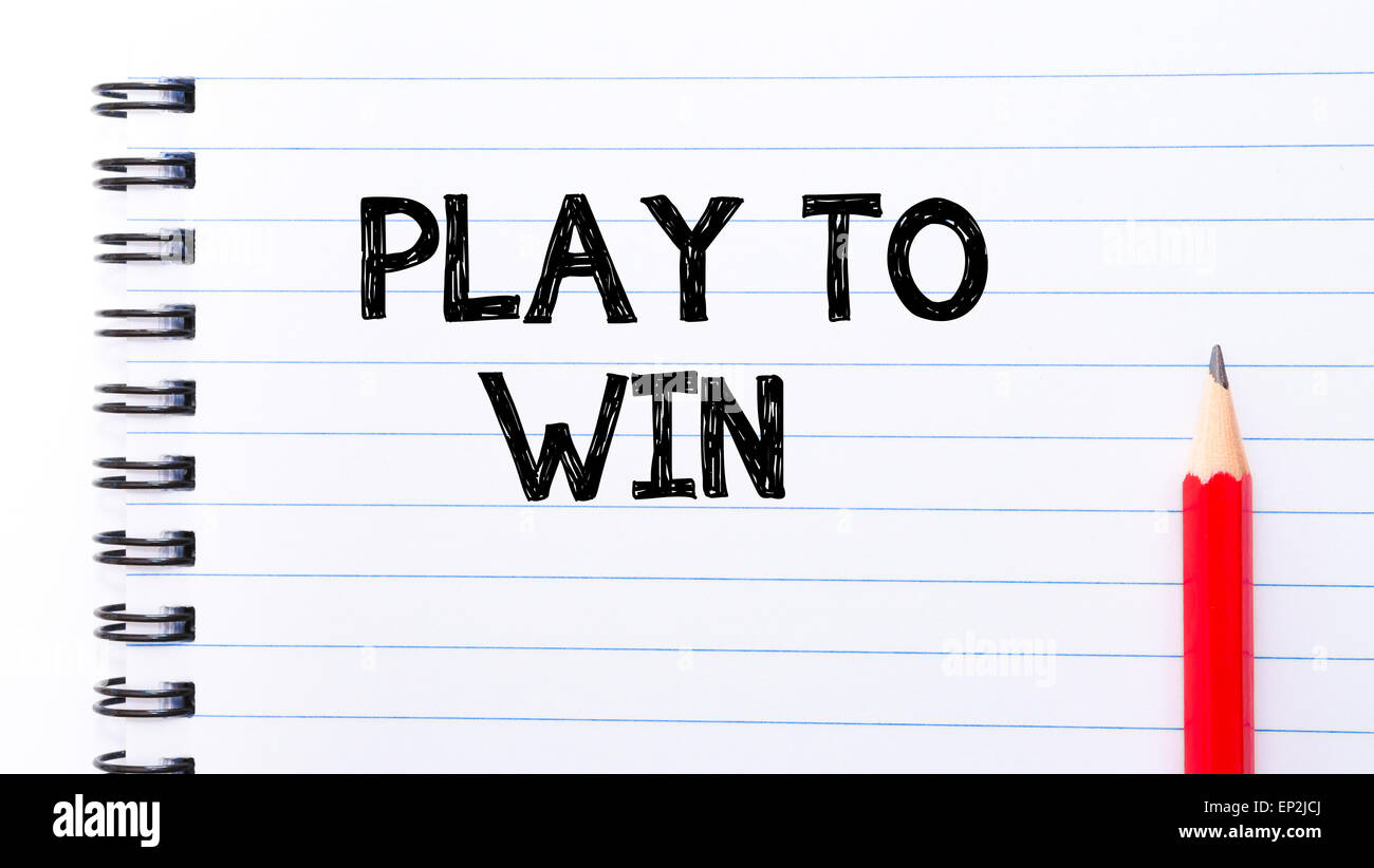Play to Win Text written on notebook page, red pencil on the right ...