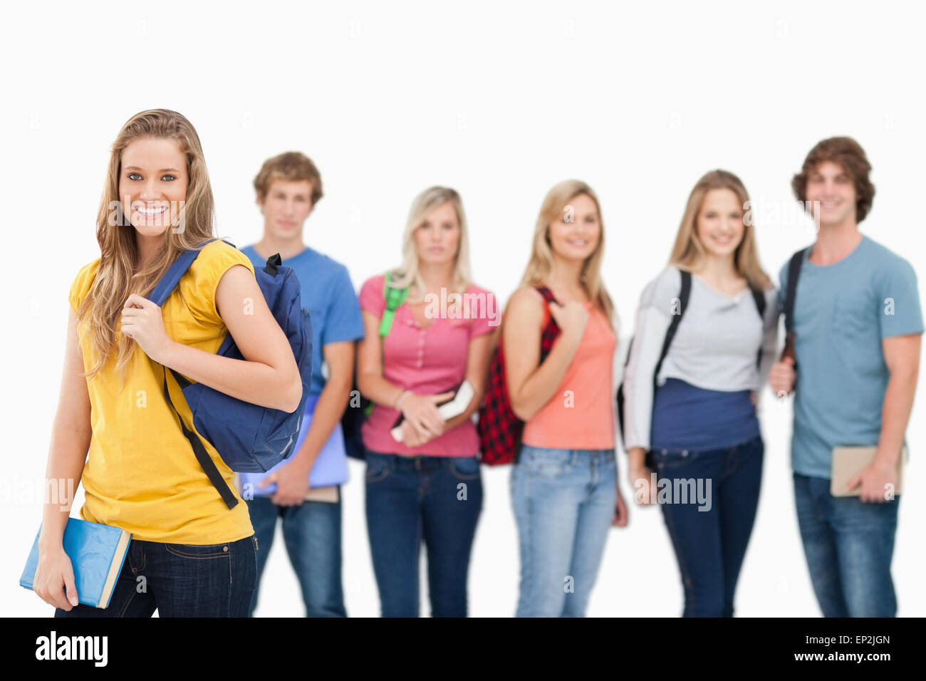 A woman standing in front of his friends as she smiles Stock Photo - Alamy