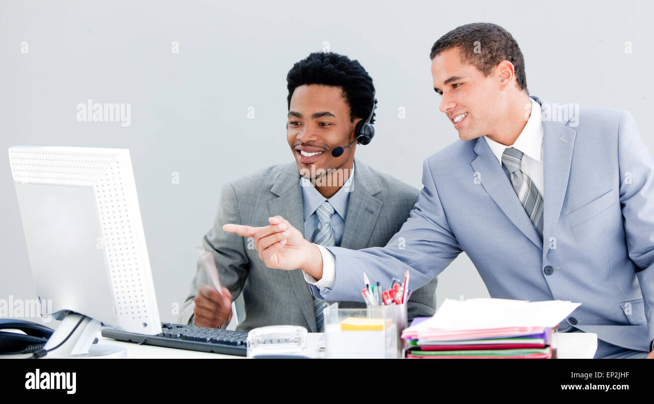 Handsome businessman pointing at the screen to show the results to his ...