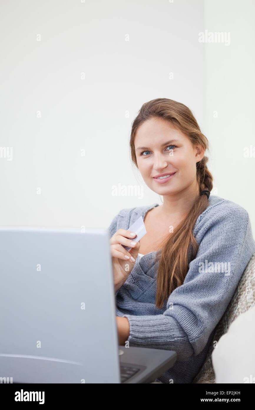 Woman sitting while using her tablet computer Stock Photo - Alamy