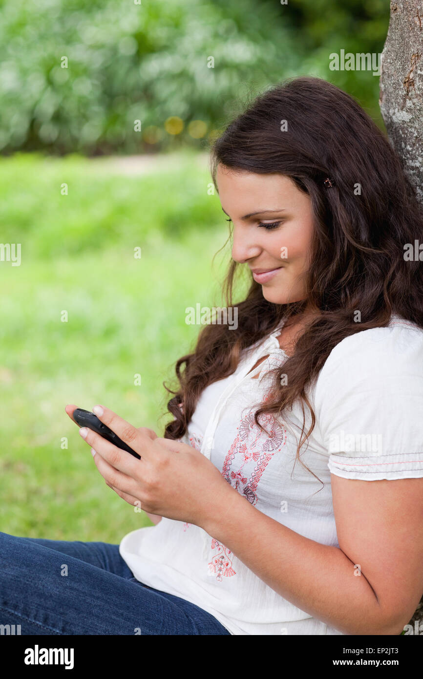 One woman sit against tree hi-res stock photography and images - Alamy