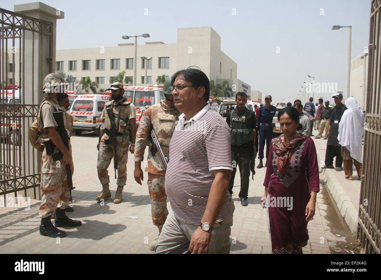Karachi, Pakistan. 13th May, 2015. People and ambulances gather outside ...