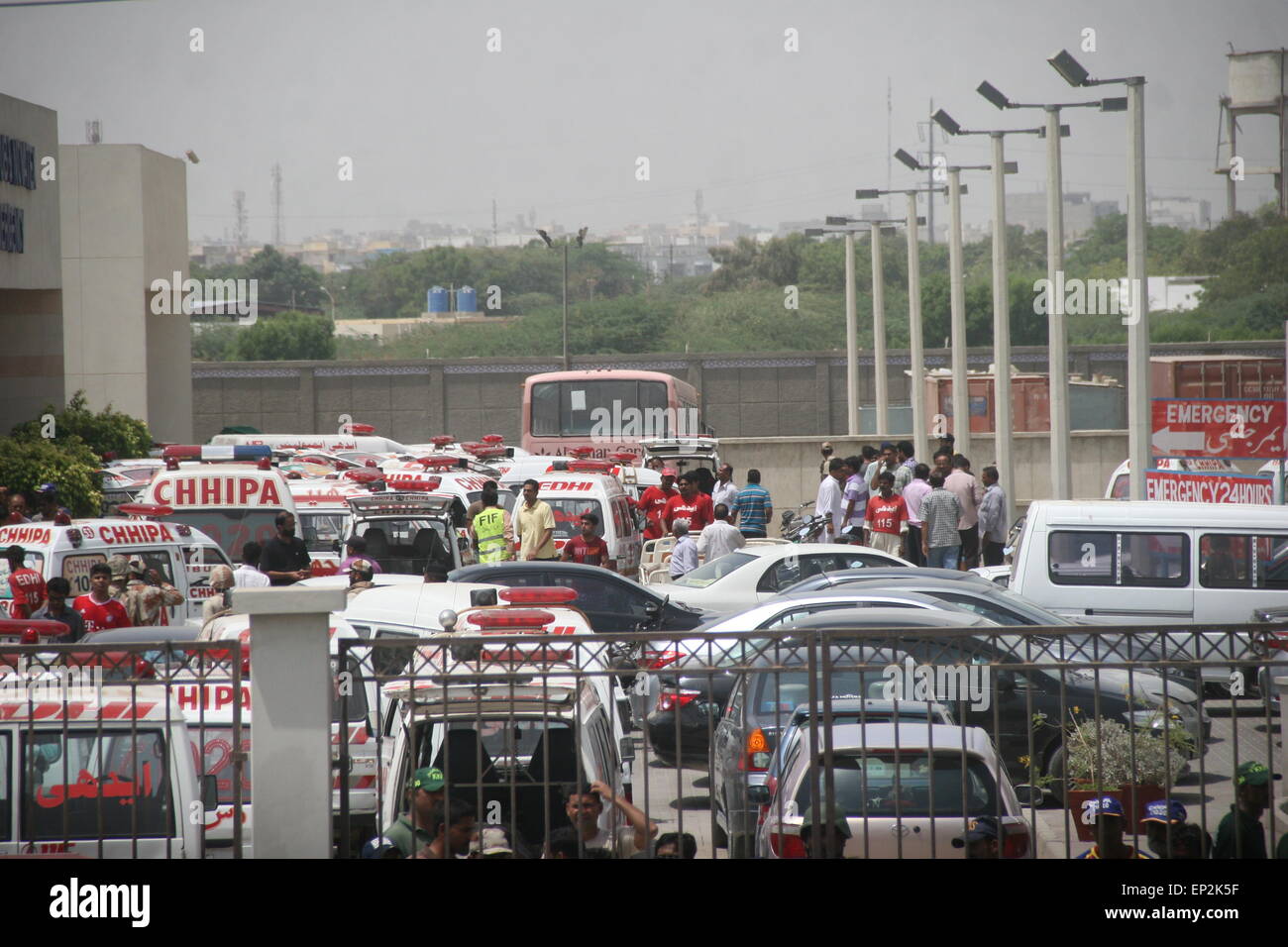 Karachi, Pakistan. 13th May, 2015. People and ambulances gather outside ...