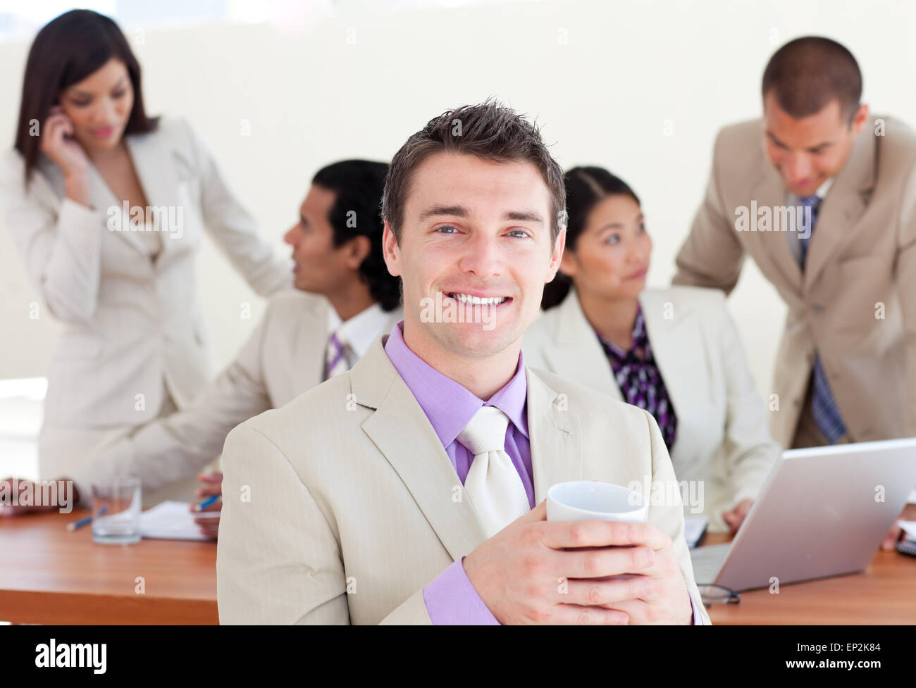 Cheerful manager drinking a coffee Stock Photo - Alamy
