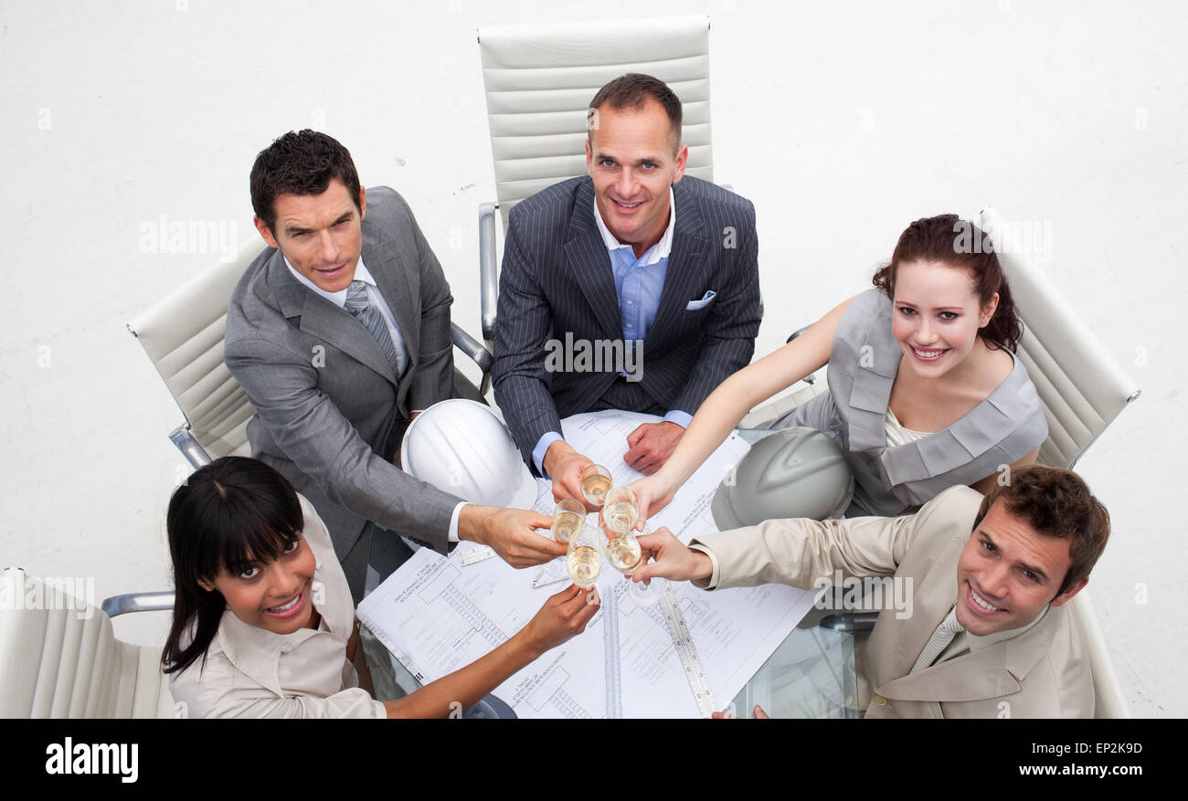 Group of architects celebrating a success in the office Stock Photo - Alamy