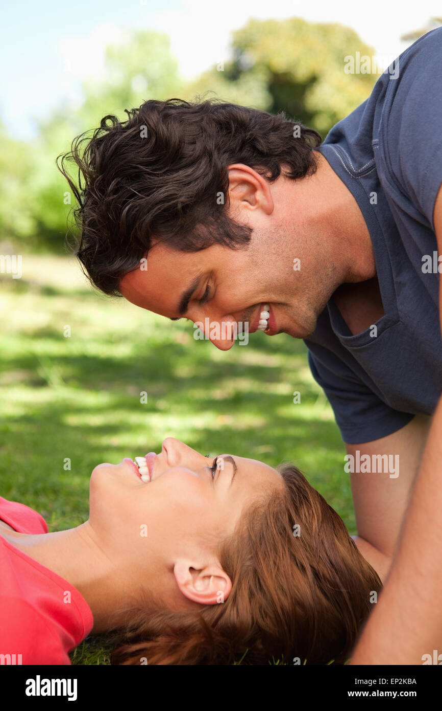 Man smiling as he looks down towards his friend Stock Photo - Alamy