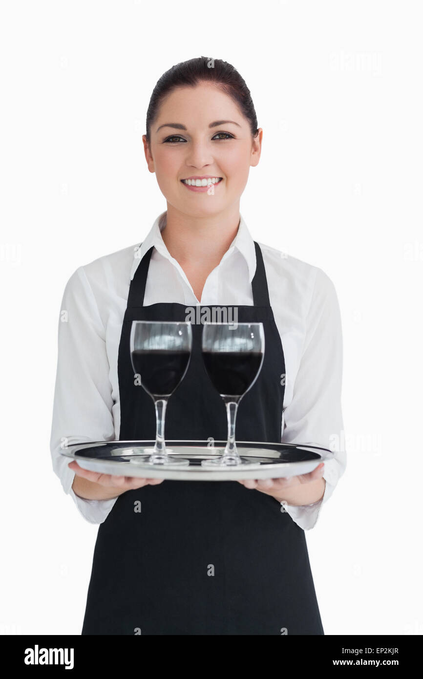 Cheerful waitress holding two glassed of wine Stock Photo - Alamy