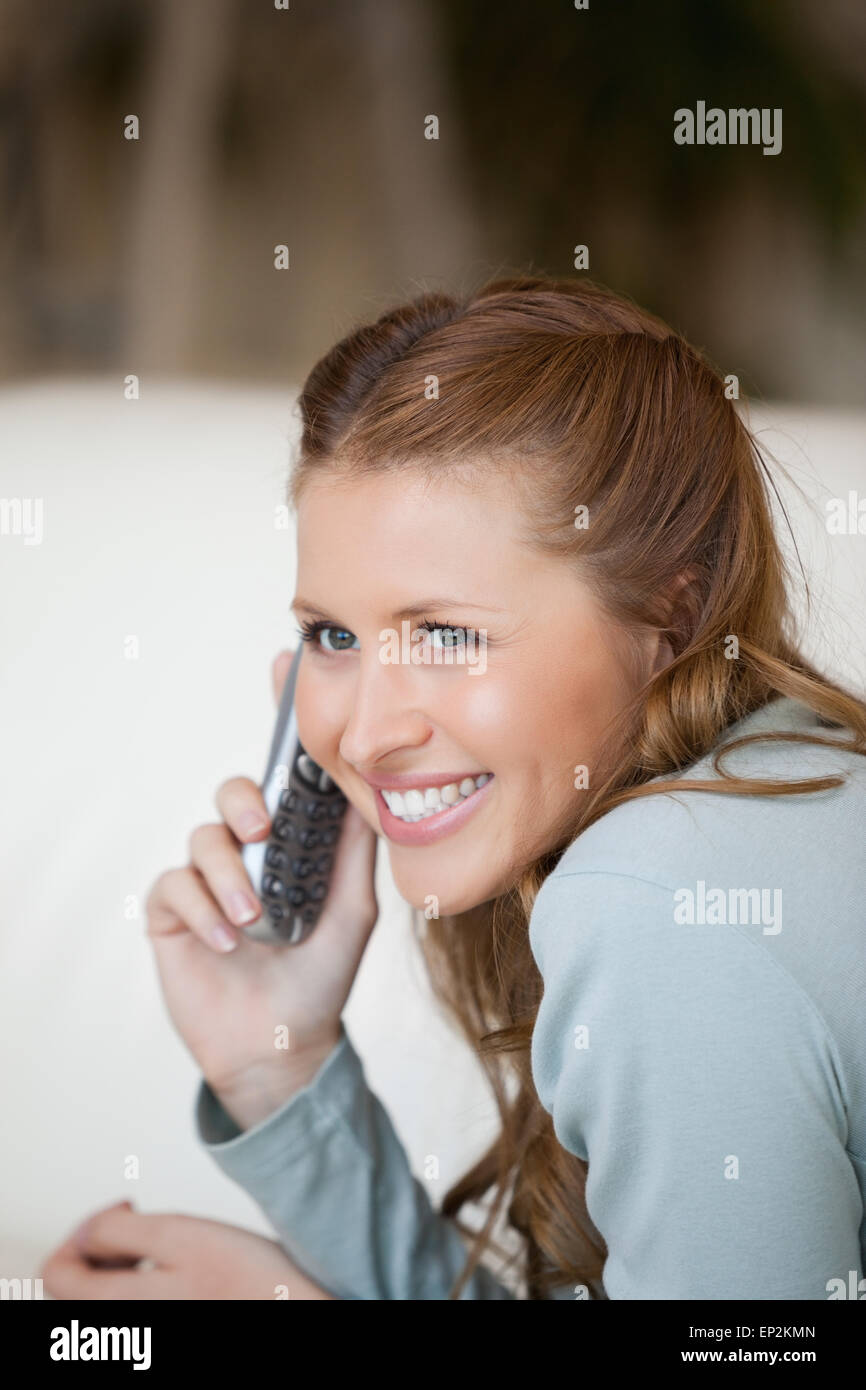 Woman smiling while phoning Stock Photo - Alamy