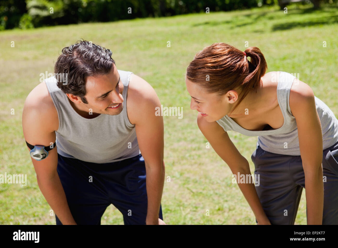 Man and a woman bending over while looking at each other Stock Photo ...