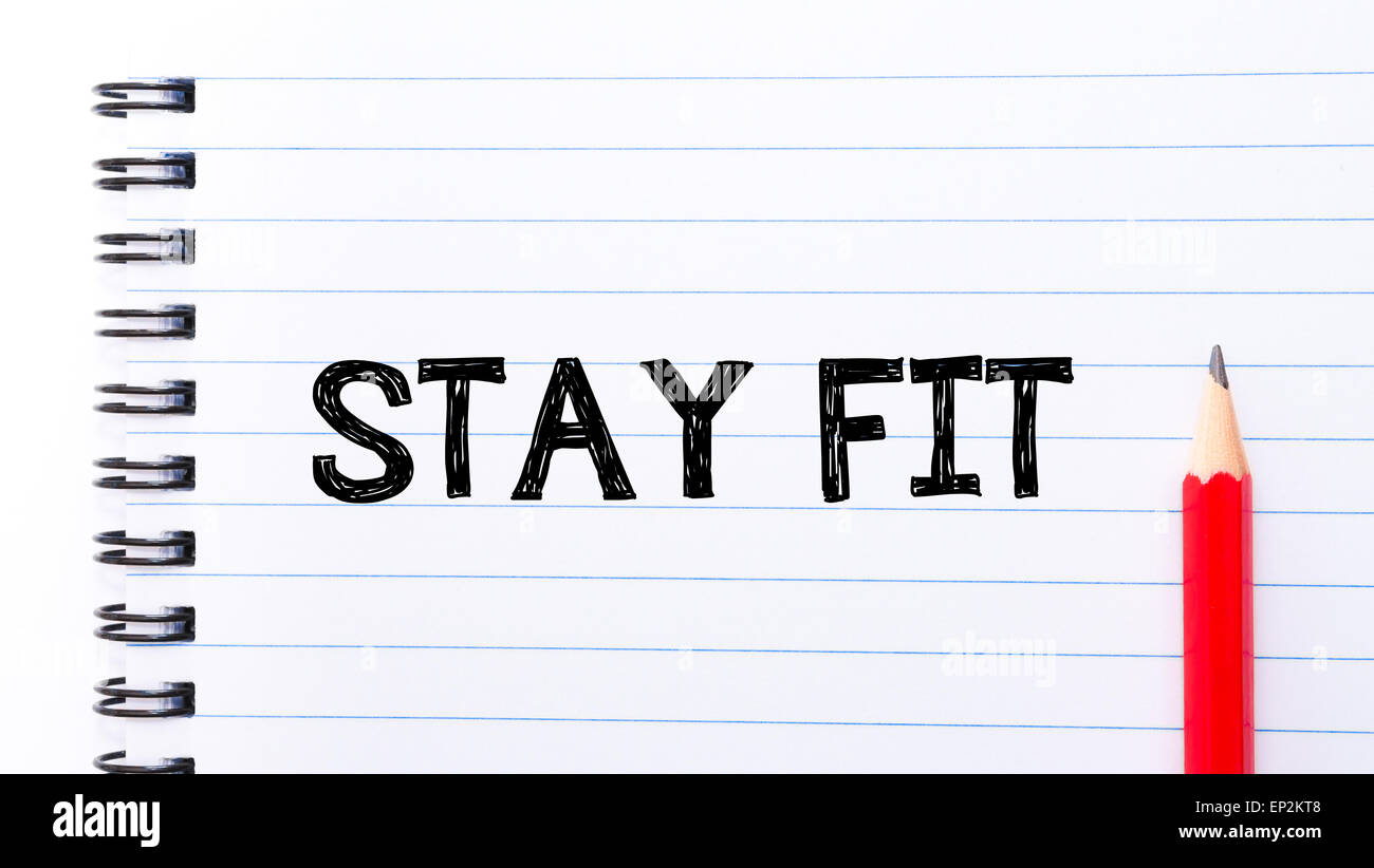 Stay Fit Text written on notebook page, red pencil on the right ...