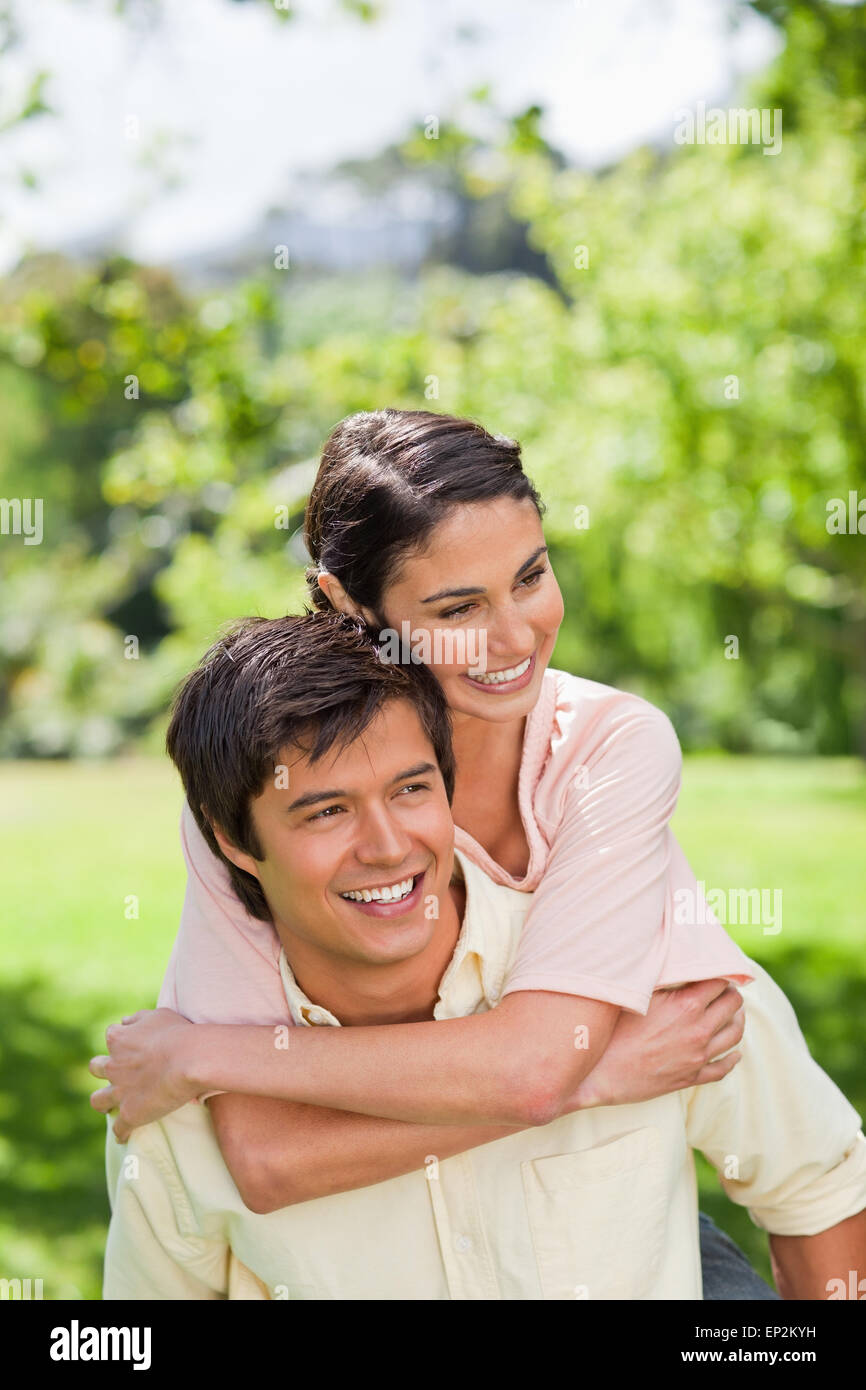 Woman smiling as she is getting a ride on her friends back Stock Photo ...