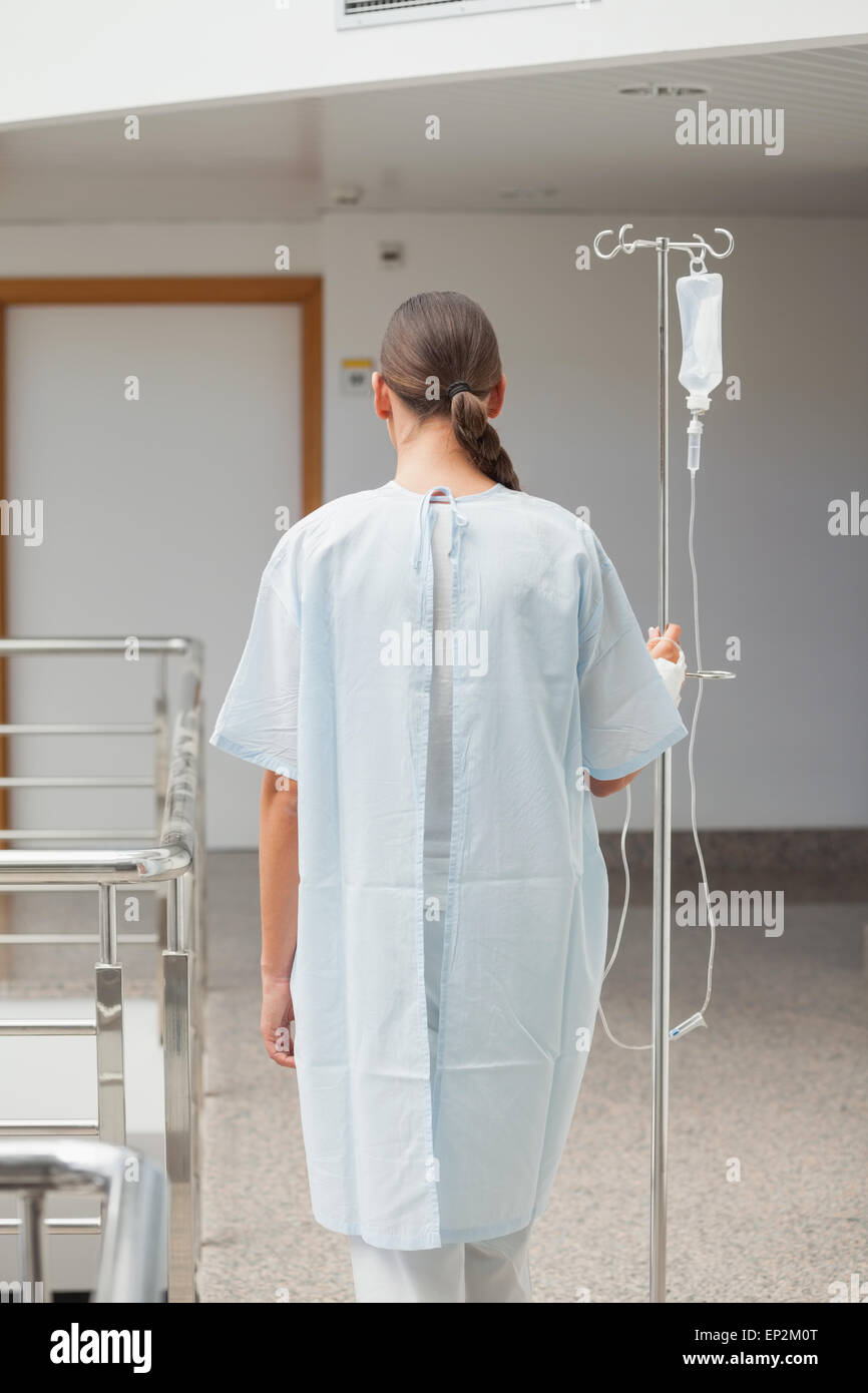 Rear view of a female patient holding a drip stand Stock Photo - Alamy