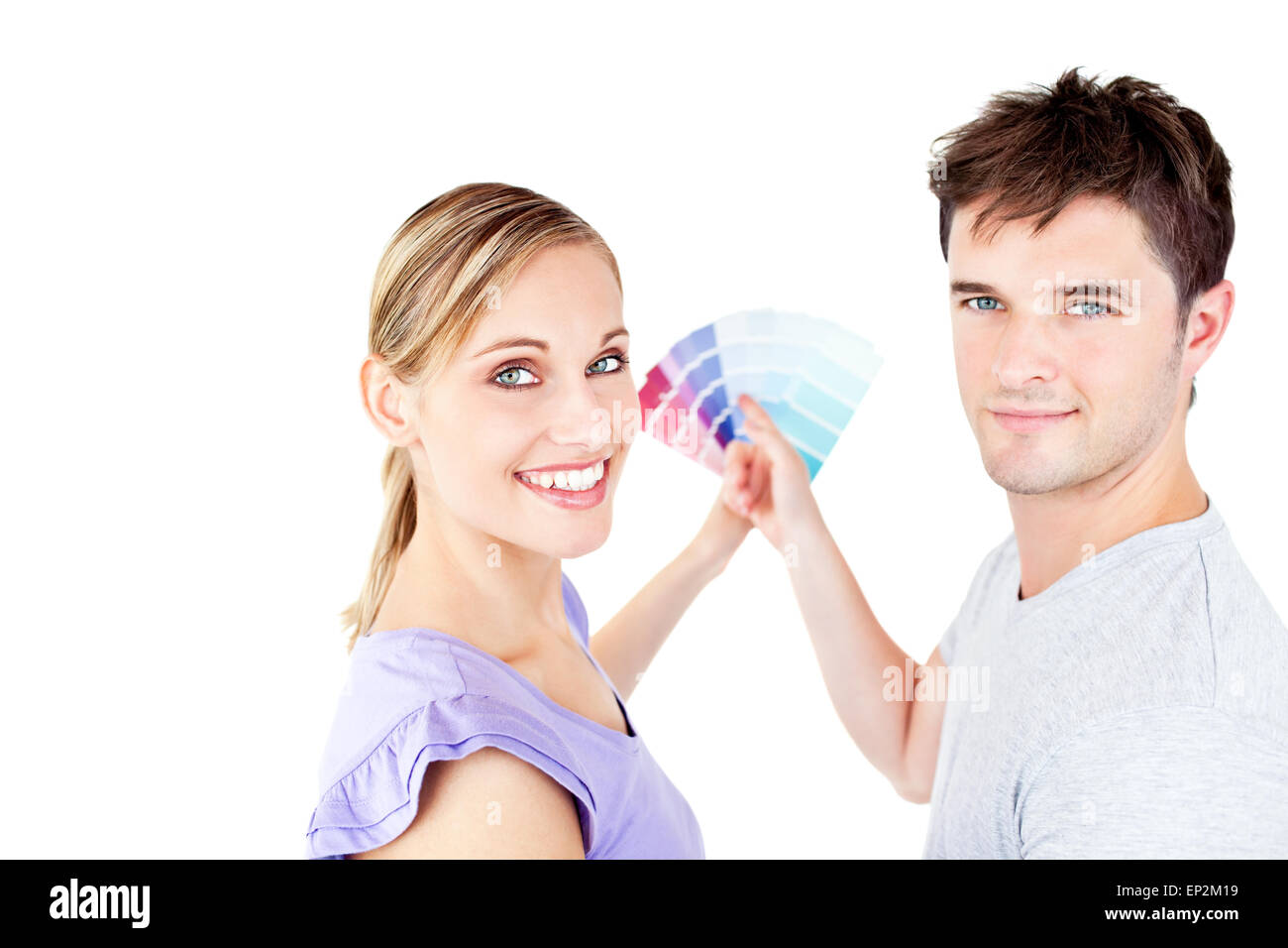 Smiling young couple choosing color for a room Stock Photo - Alamy
