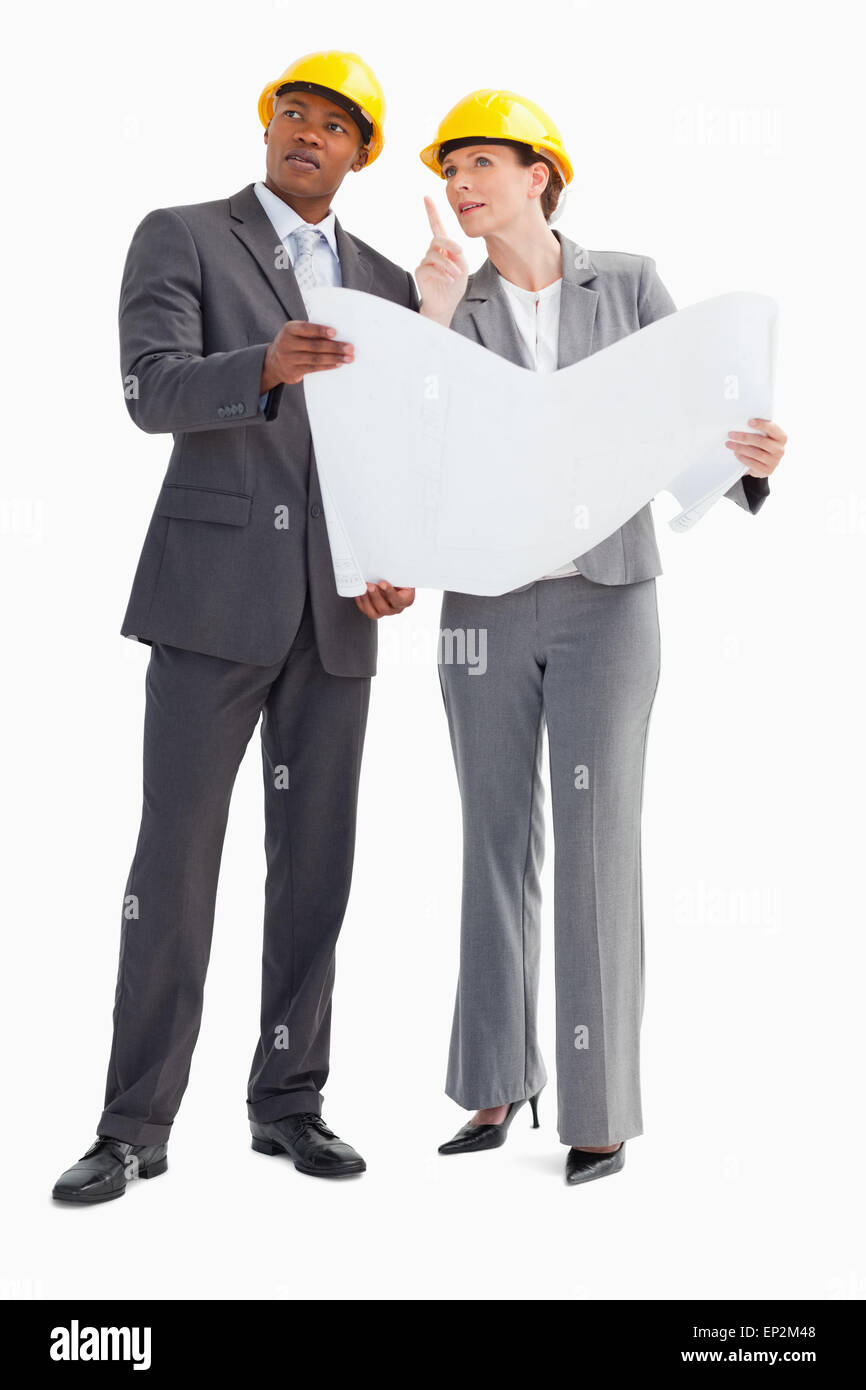 Business people wearing hard hats are discussing Stock Photo - Alamy