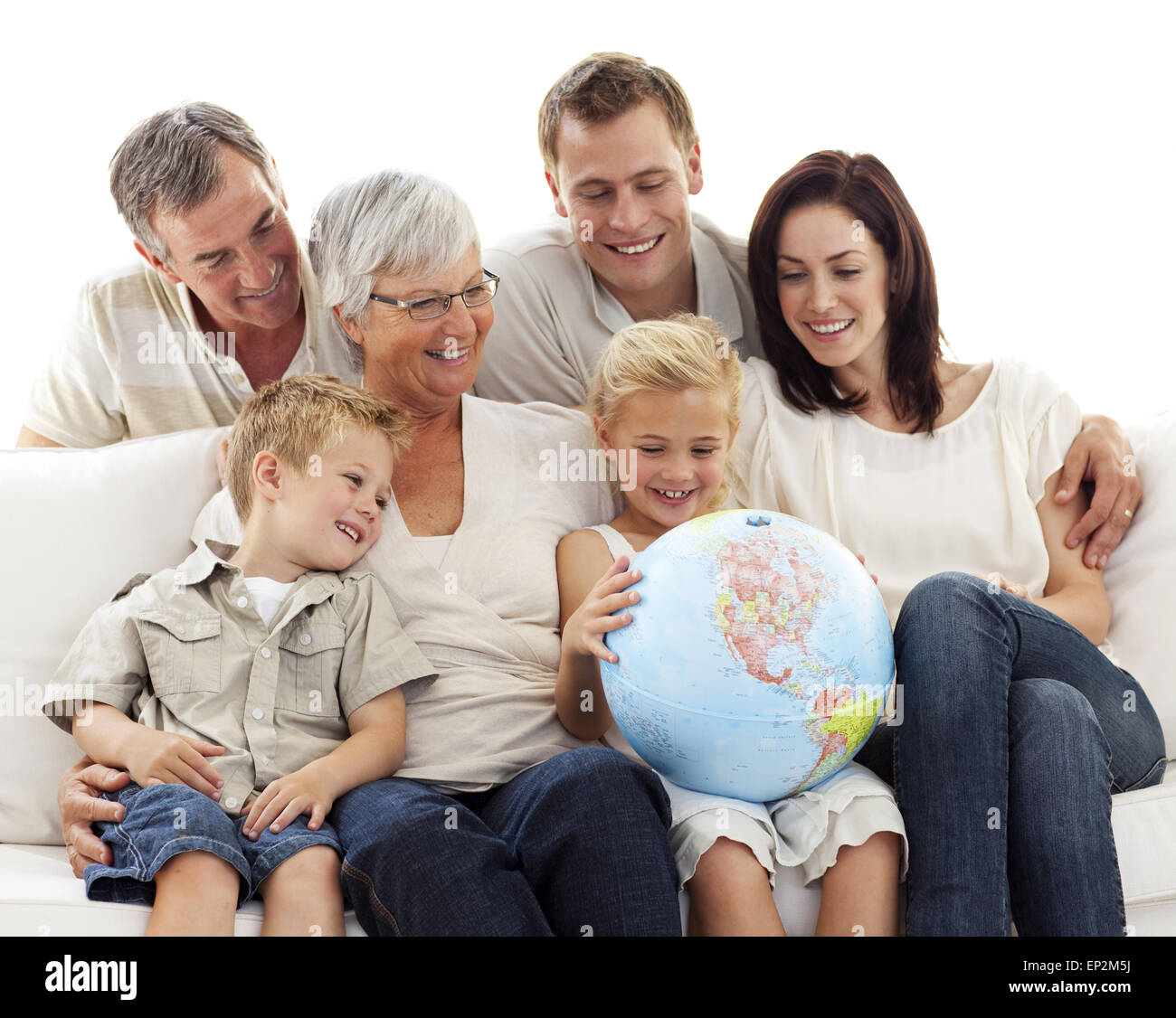 Big family on sofa looking at a terrestrial globe Stock Photo - Alamy