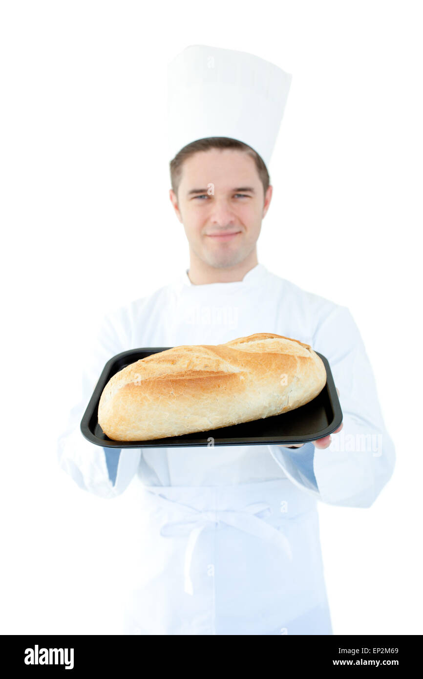 Smiling male cook holding a bread into the camera against white ...
