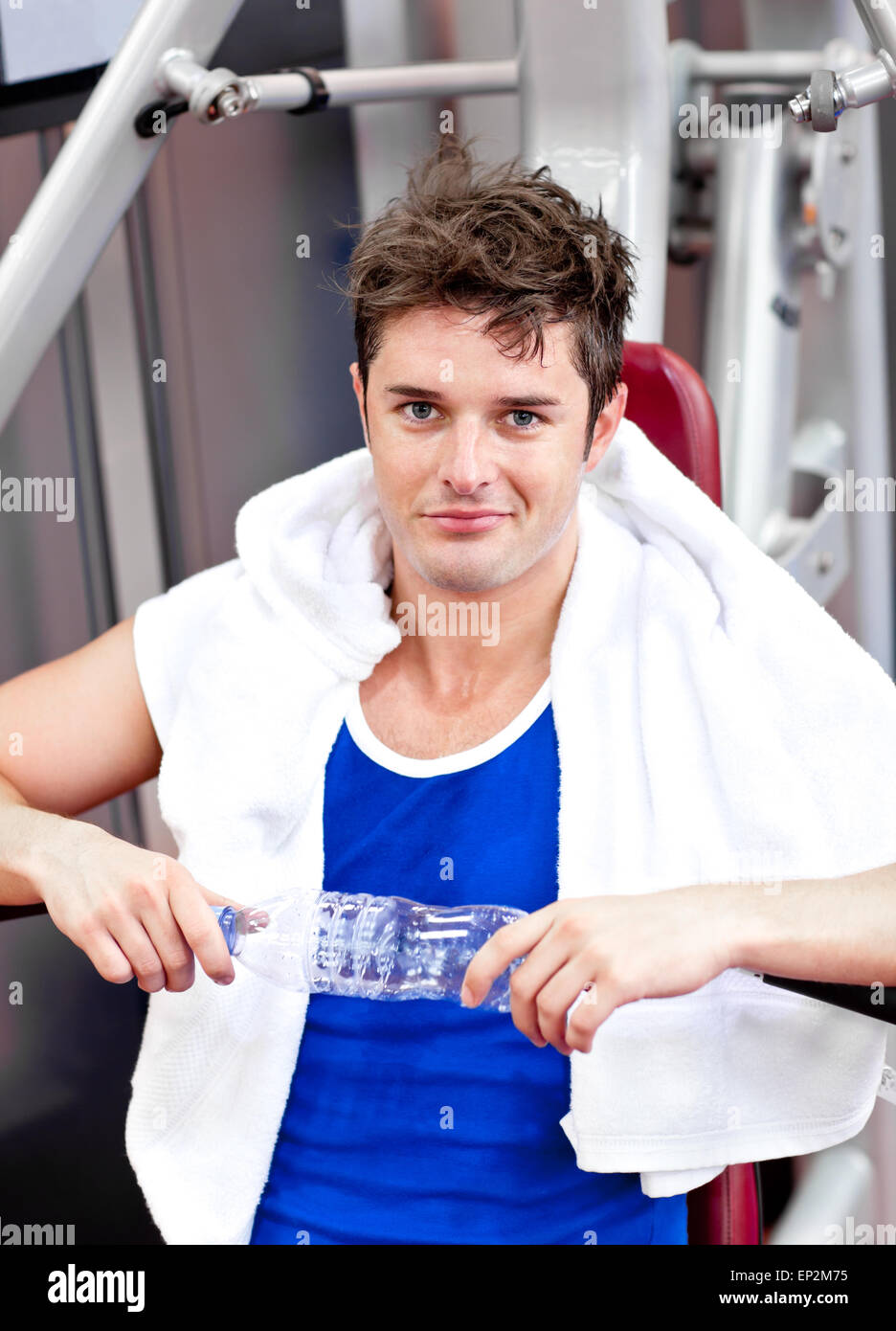 handsome man sitting on a bench press after exercises Stock Photo - Alamy
