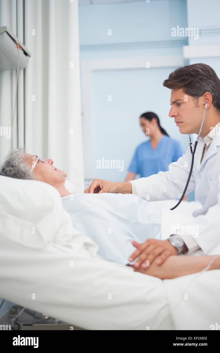 Doctor auscultating a patient with a stethoscope Stock Photo - Alamy