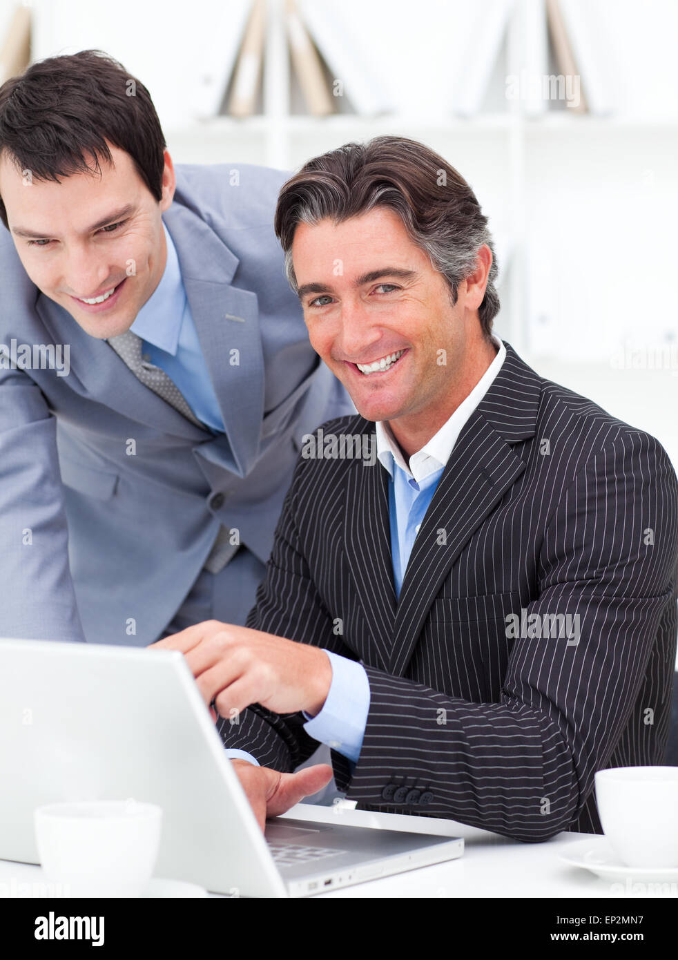 Two businessmen working at a computer Stock Photo - Alamy