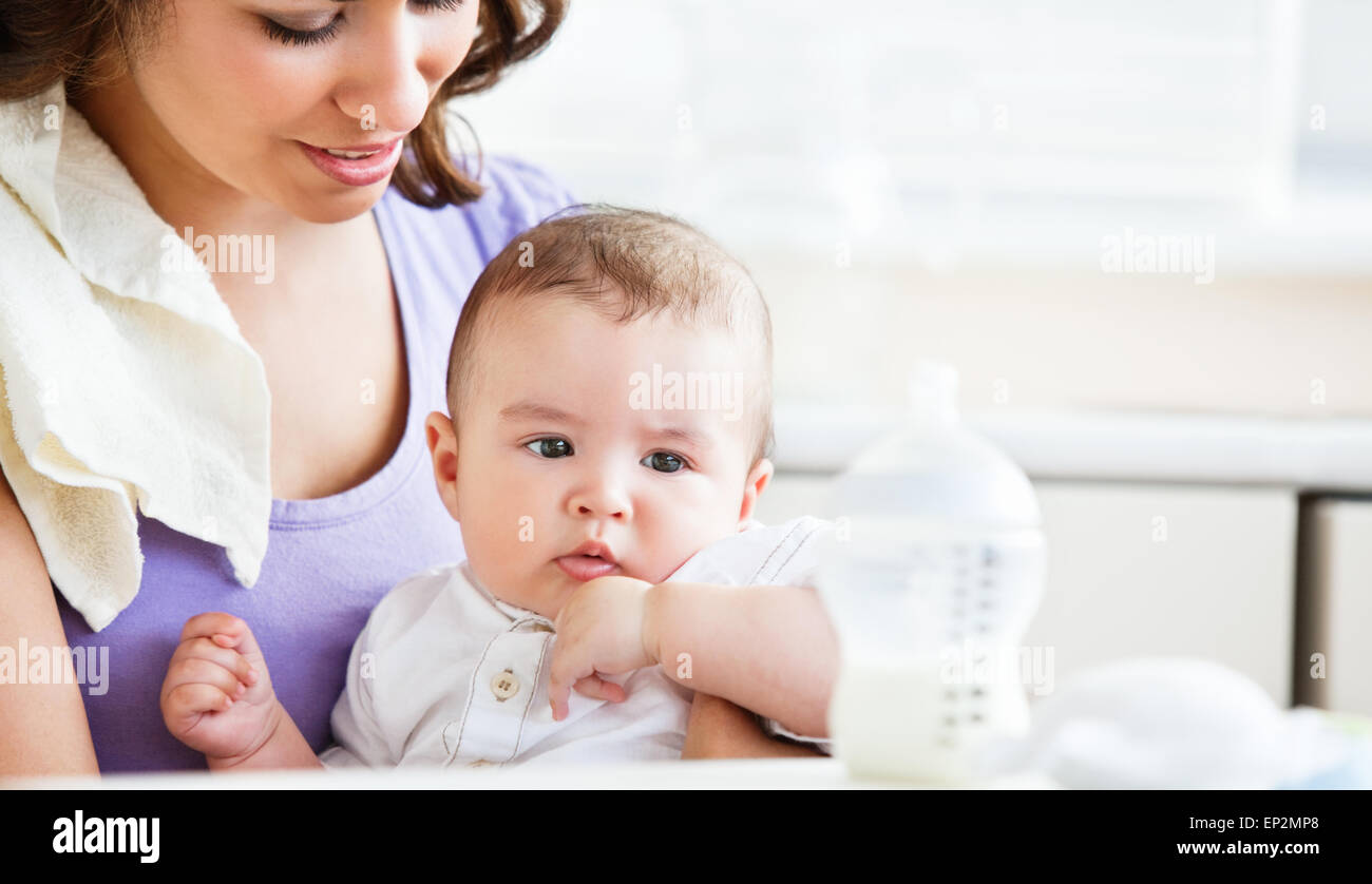 Portrait of a charming mother taking care of her adorable baby in the kitchen Stock Photo - Alamy