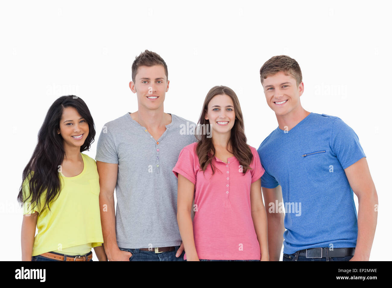 Four people standing beside one another and smiling Stock Photo - Alamy