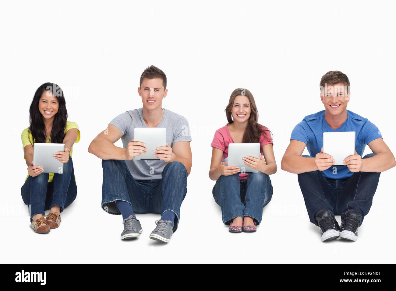 A group of people holding tablets as they look at the camera Stock ...